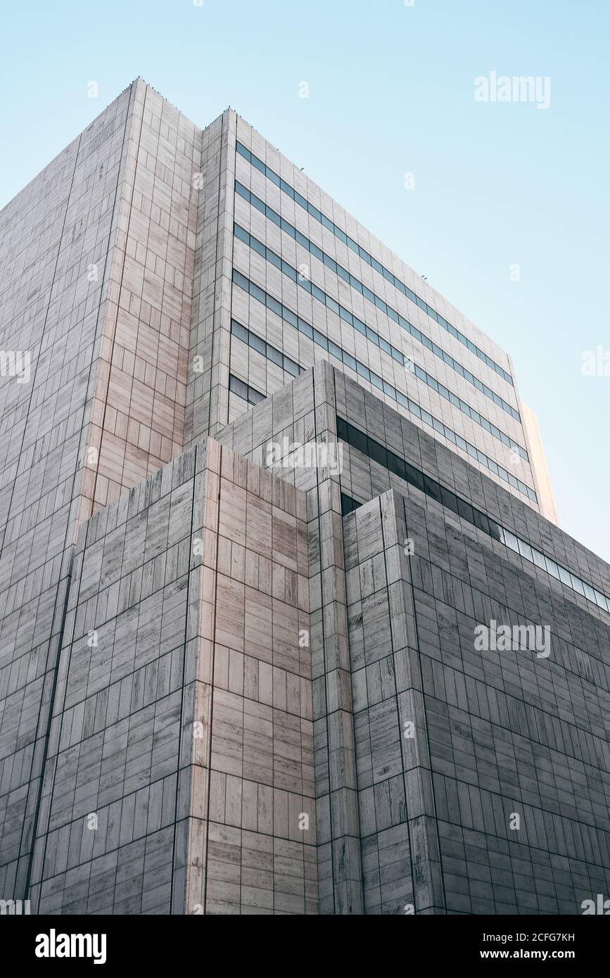 From below modern building with creative architecture under blue sky on ...