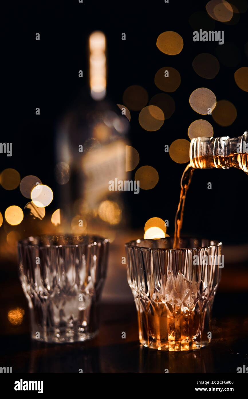 Close up view alcohol drink pouring from bottle to the glass Stock ...