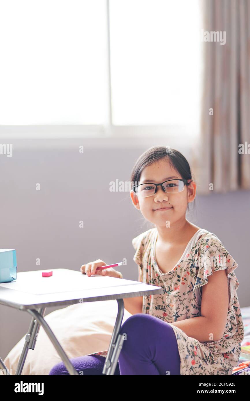 Portrait of girl with her table of homework Stock Photo - Alamy