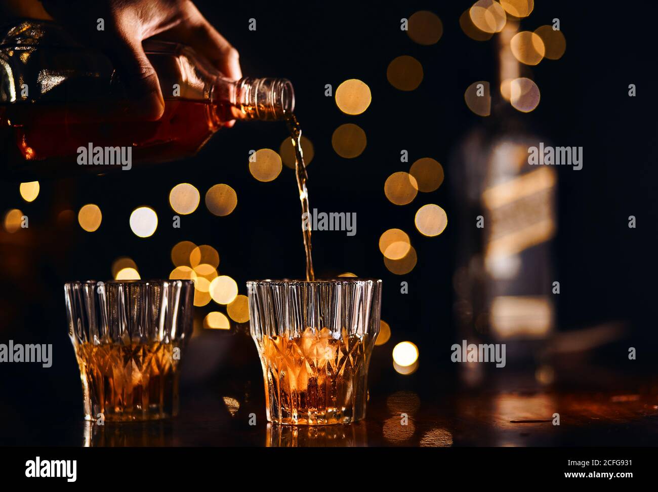 Close up view alcohol drink pouring from bottle to the glass Stock ...