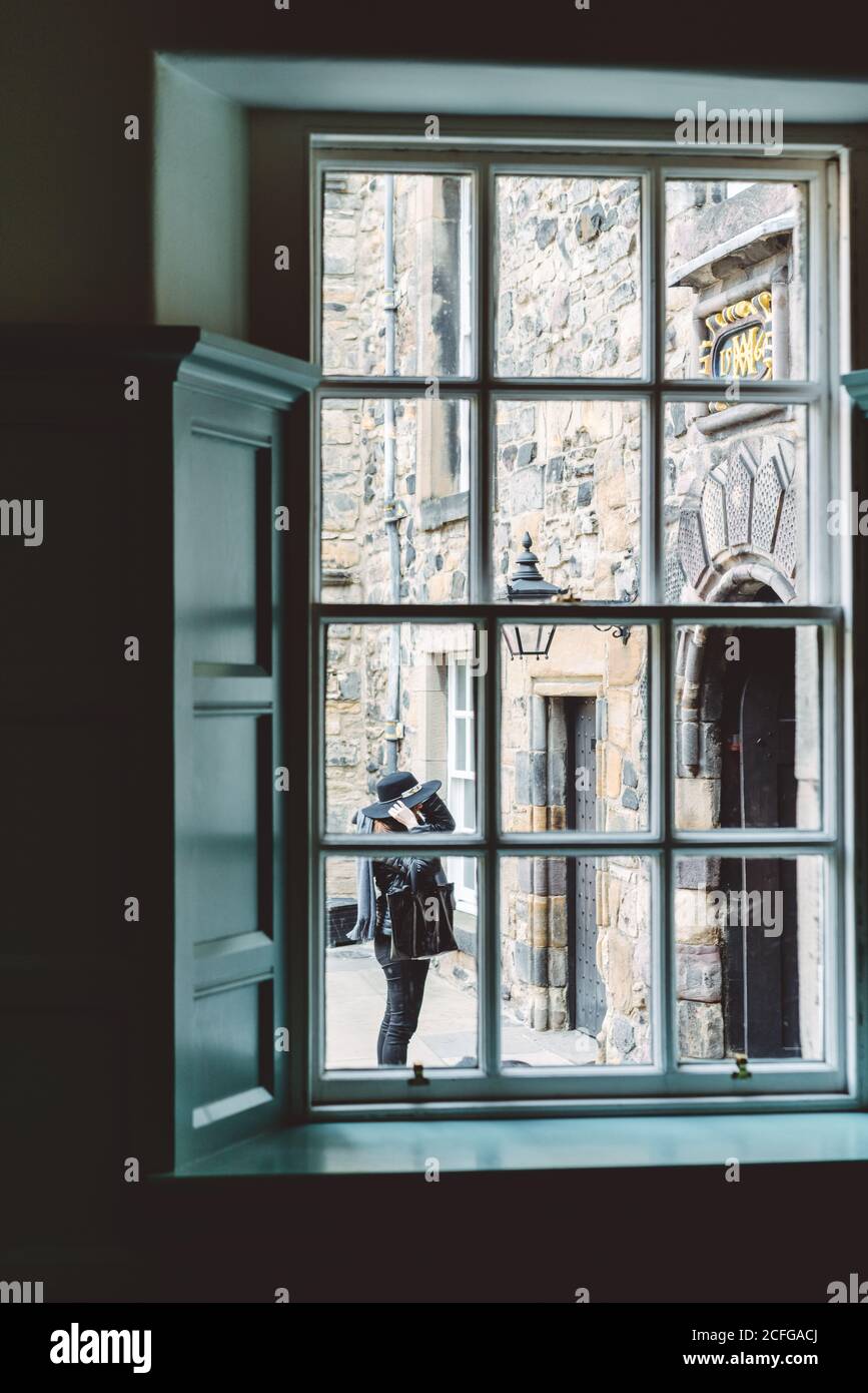 View through old window frame with aged stone building behind in soft ...