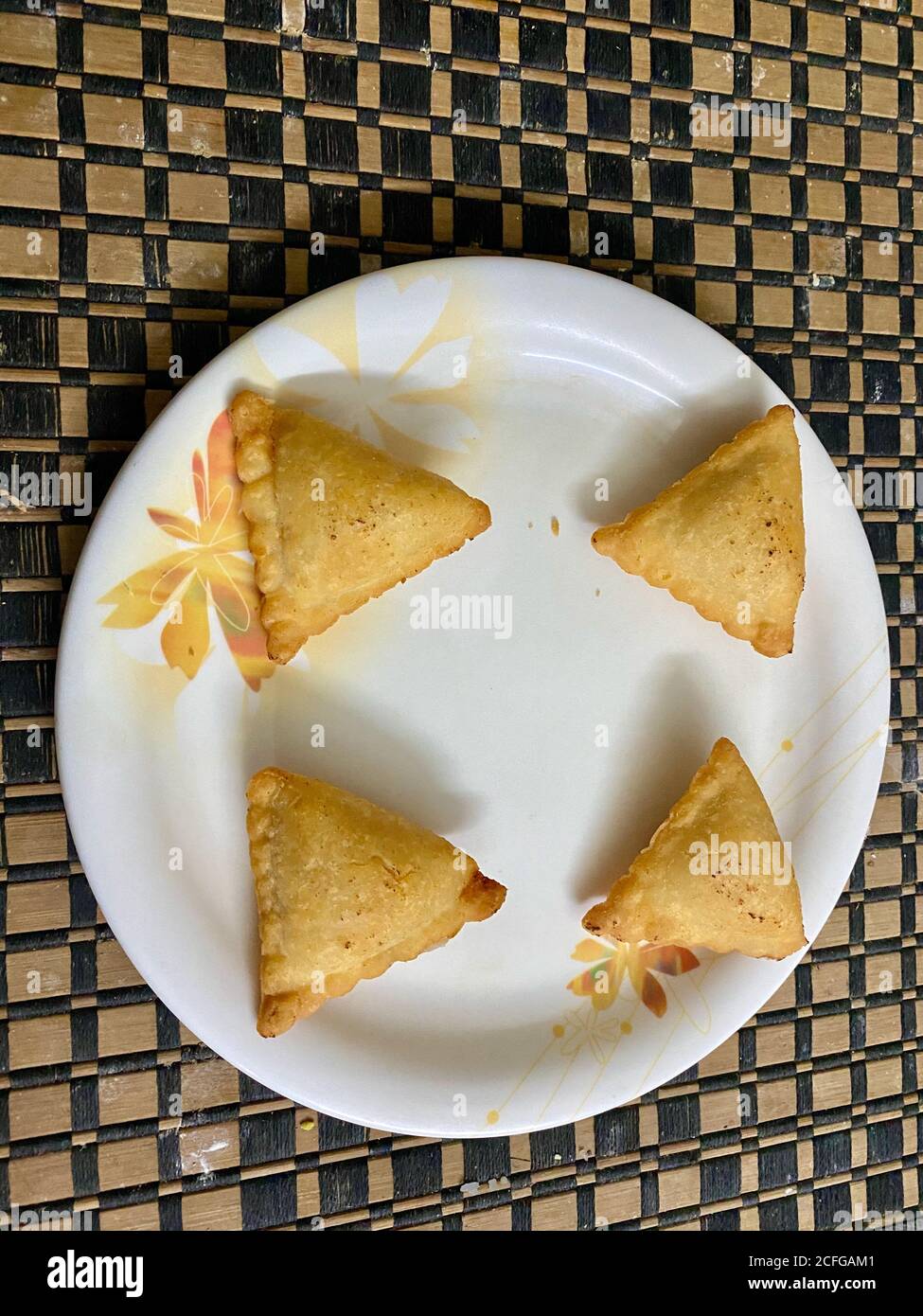 hot samosa getting ready to be served in a plate for evening snacks ...