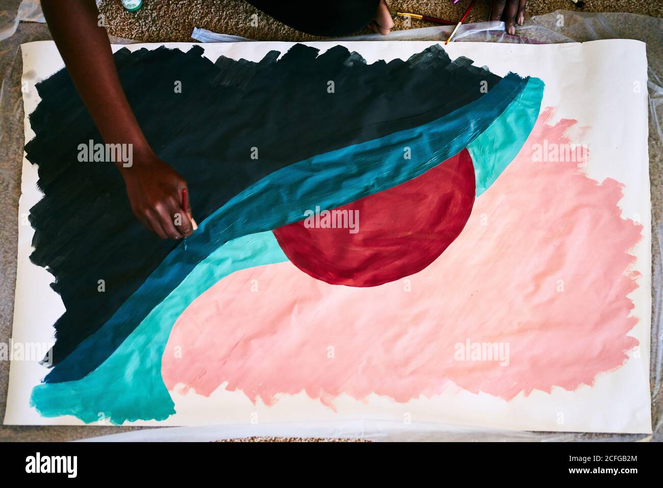 Focused ethnic female athlete doing exercises on parallel bars during ...