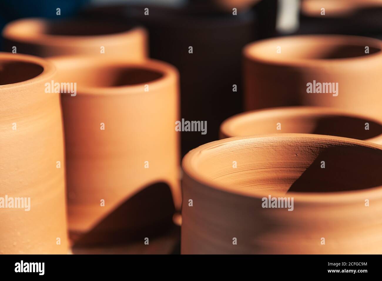 Closeup set of traditional clay pots placed on table in pottery Stock ...