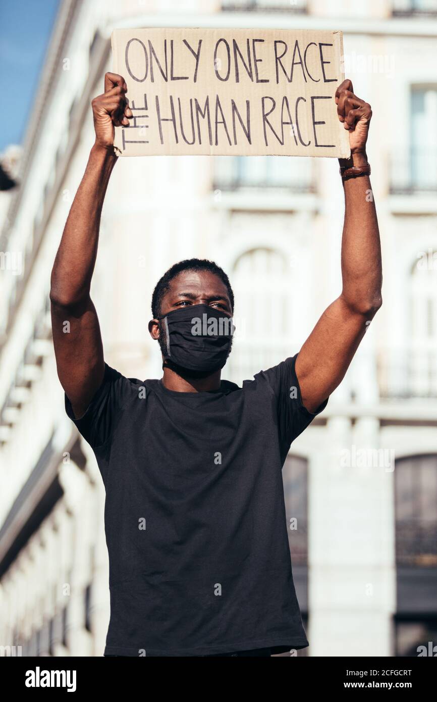 man crying and protesting at a rally for racial equality holding a ...