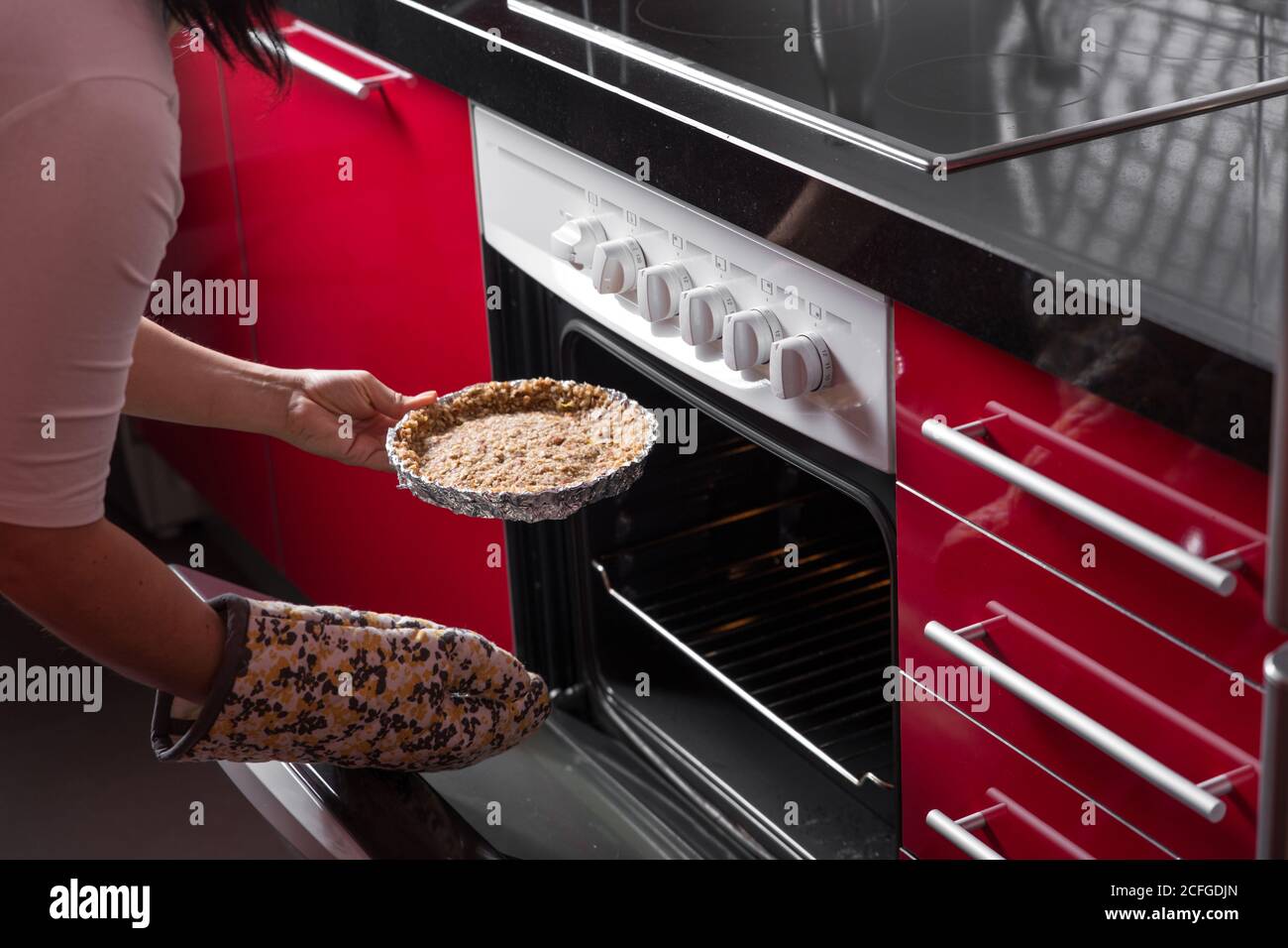Woman putting cake in hi-res stock photography and images - Alamy