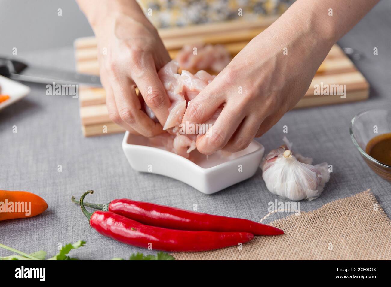Woman cooking chicken hi-res stock photography and images - Alamy