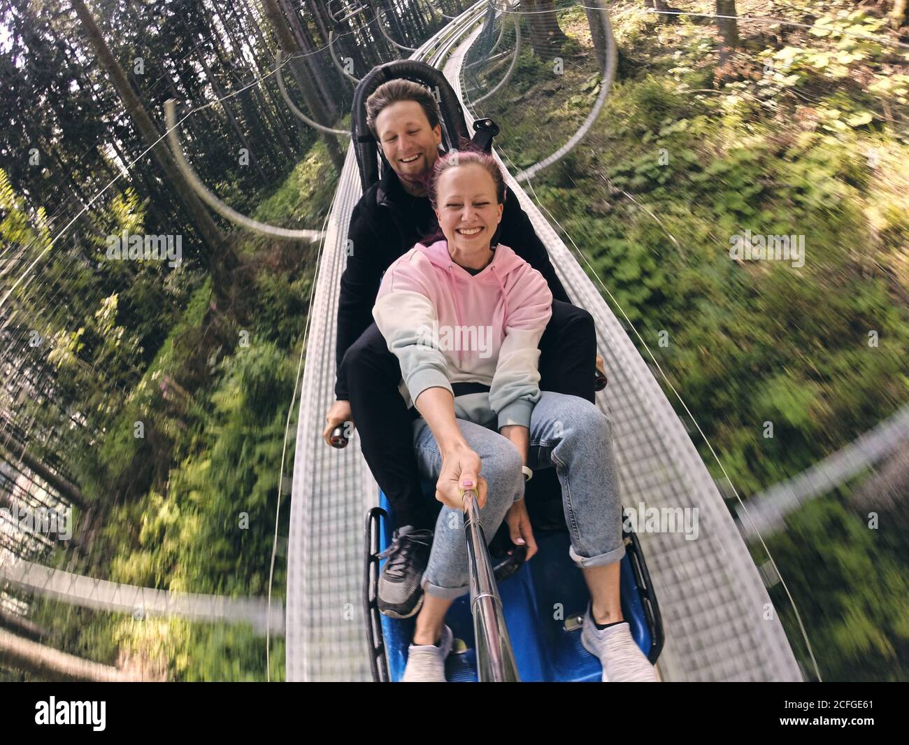 Summer toboggan run rodelbahn with many curves on a mountain. Alpine ...