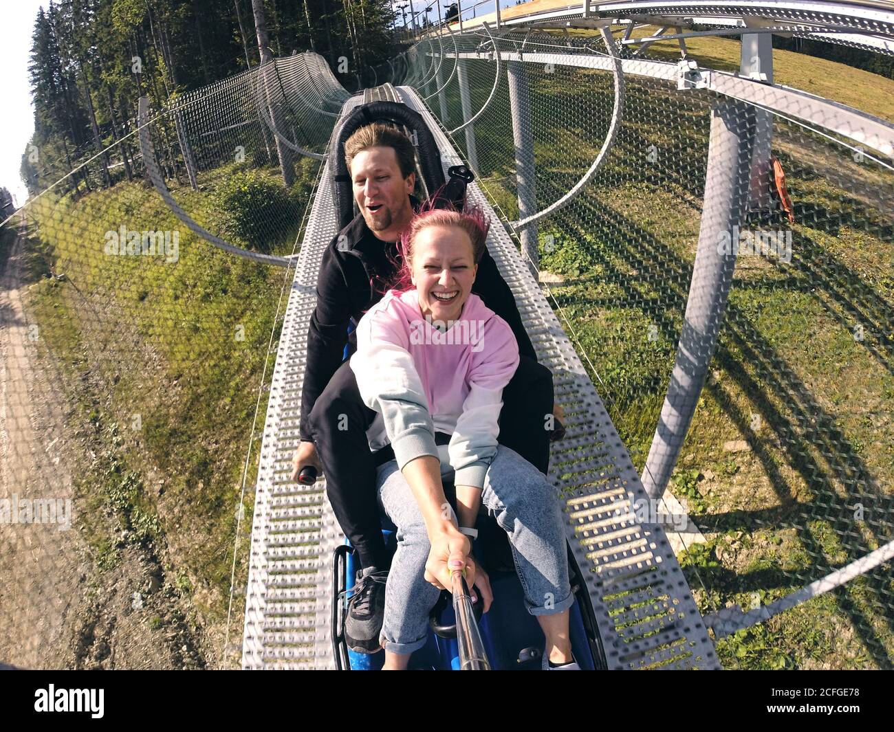 Summer toboggan run rodelbahn with many curves on a mountain. Alpine ...