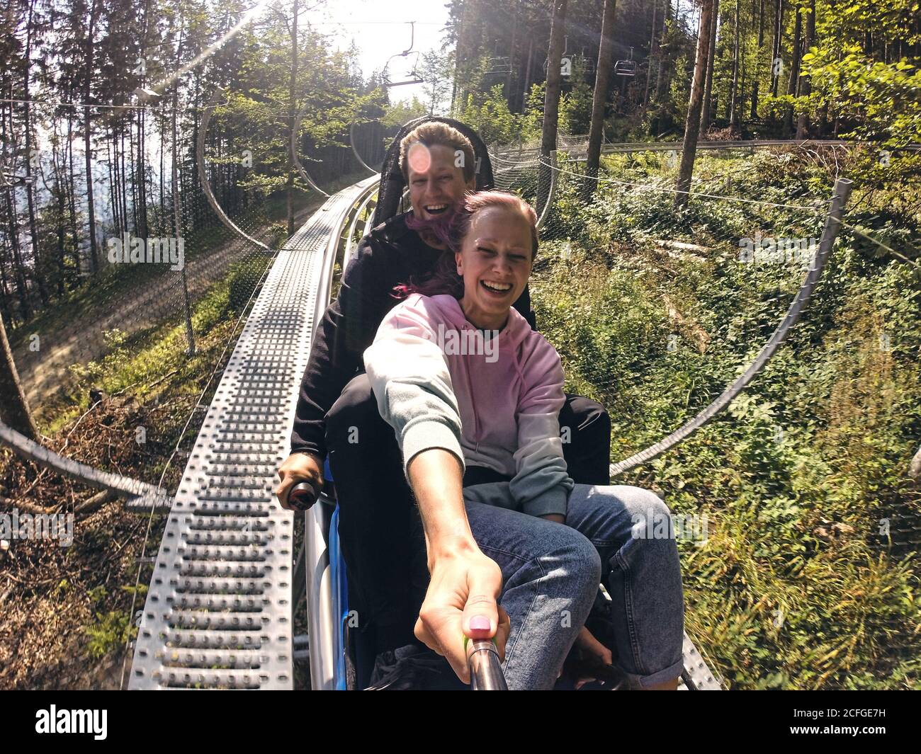 Summer toboggan run rodelbahn with many curves on a mountain. Alpine ...