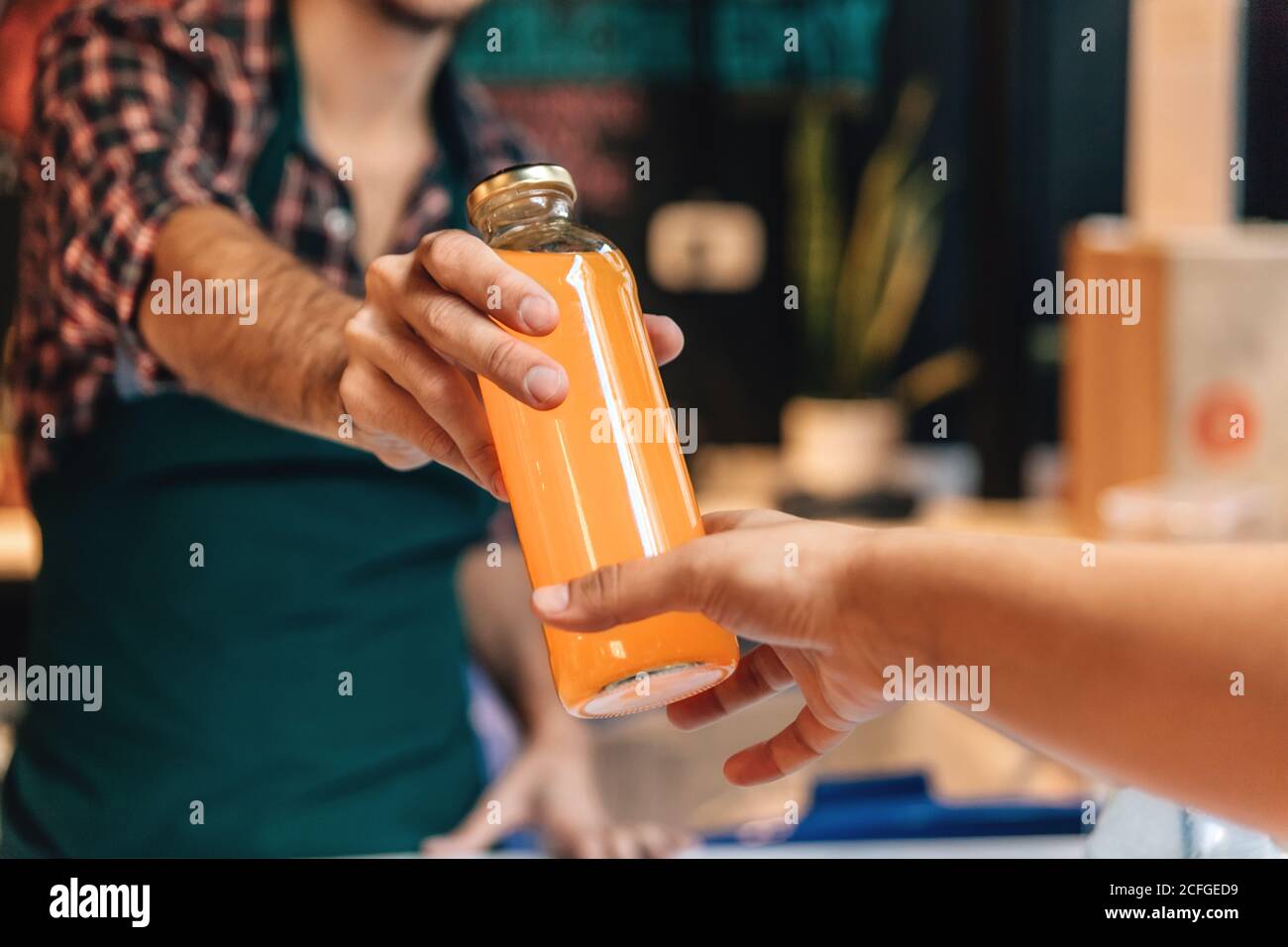 Bartender handing drink to a customer Stock Photo - Alamy