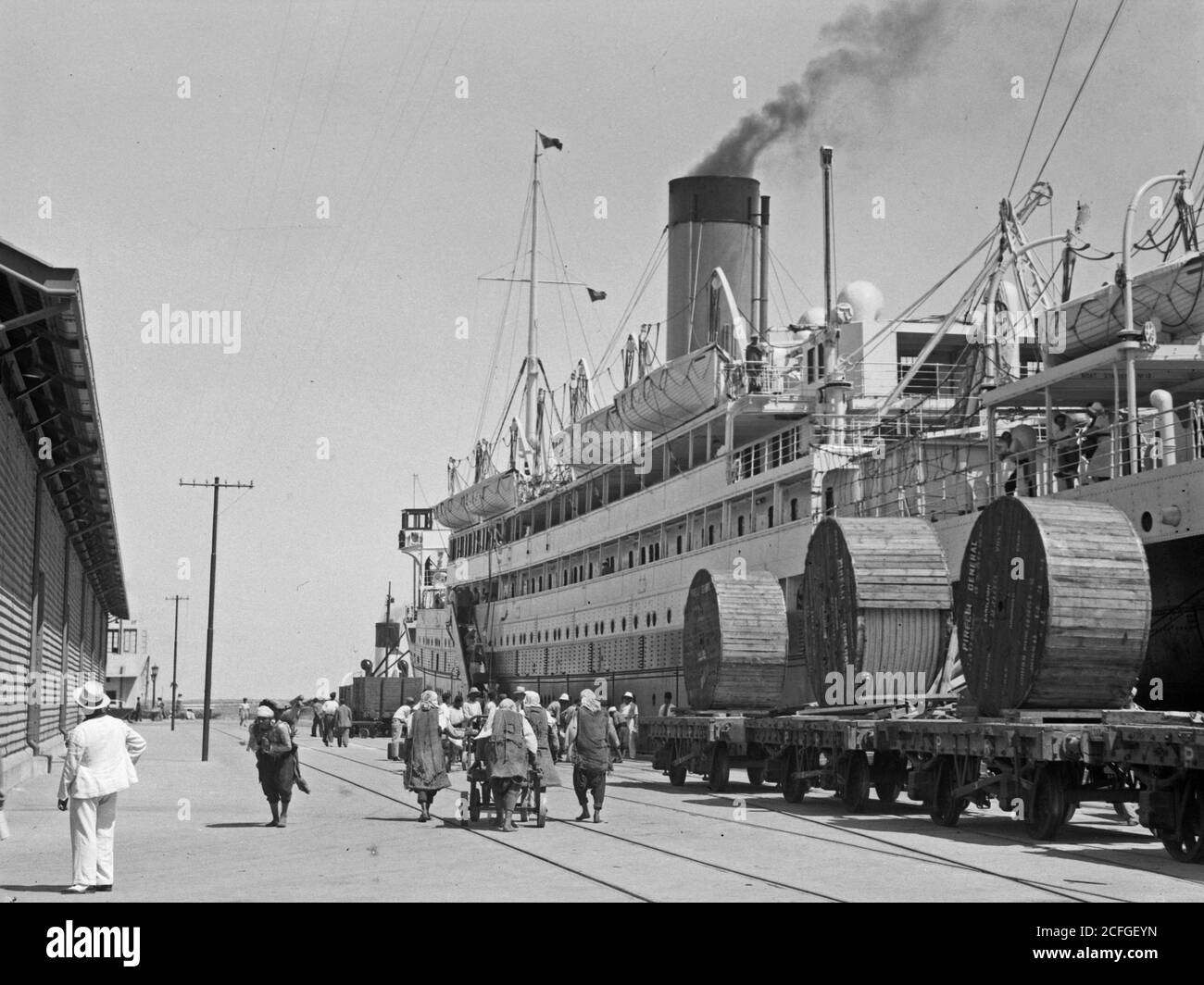 Original Caption: Haifa & environs. New Haifa Harbor. Ship tied up to ...