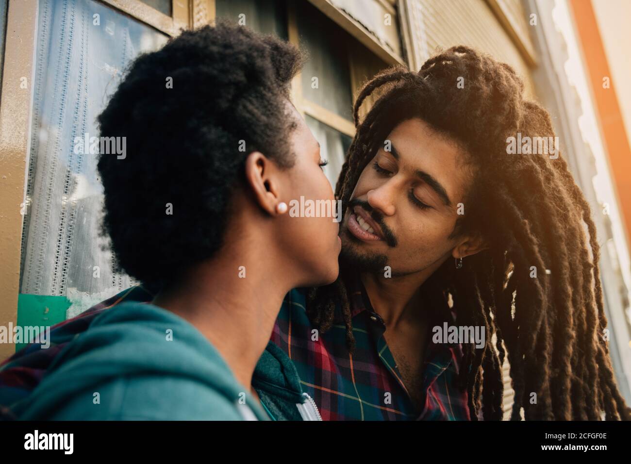Mixed race couple kissing Stock Photo - Alamy