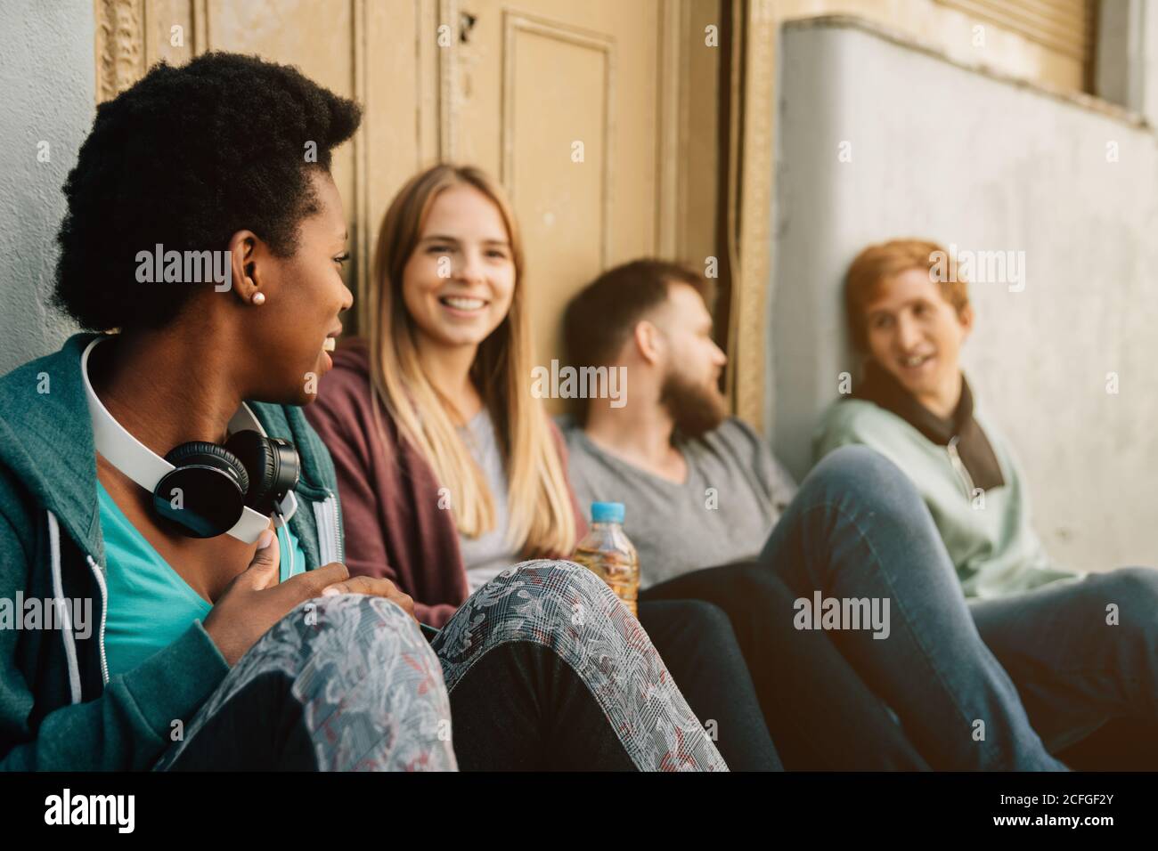 Group of friends against a wall Stock Photo - Alamy