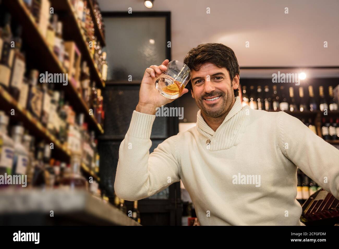 Man having a glass of drink in a winery whop Stock Photo - Alamy