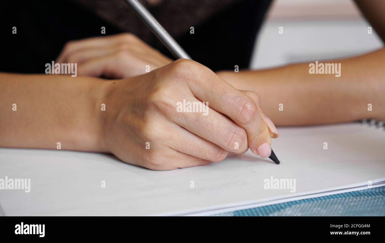 Woman hand use pencil writing on clear white sheet Stock Photo - Alamy