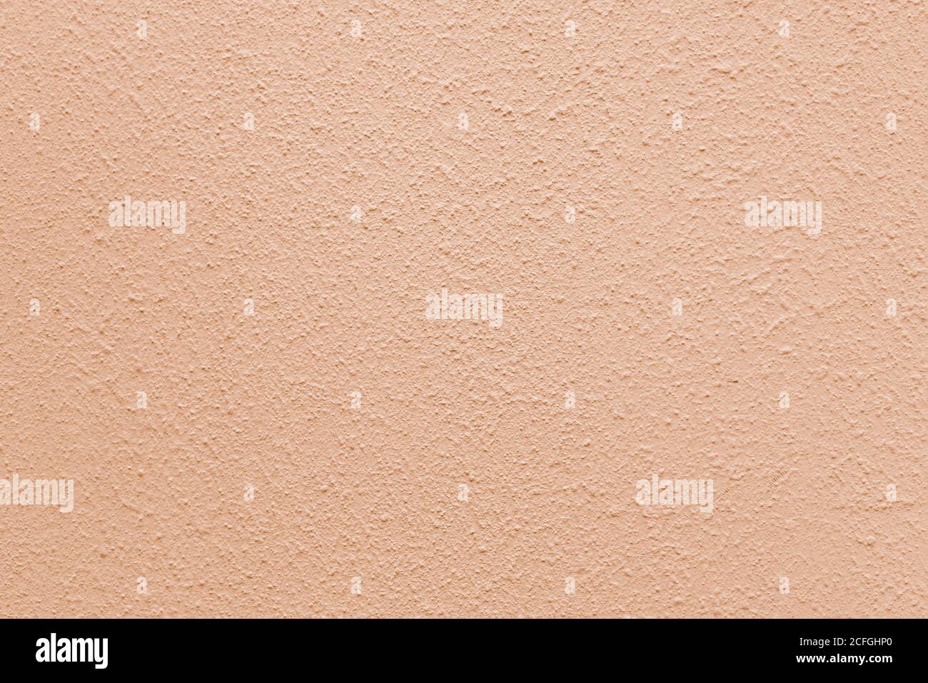 Peach wall of the building. Rough plaster surface. Abstract background ...