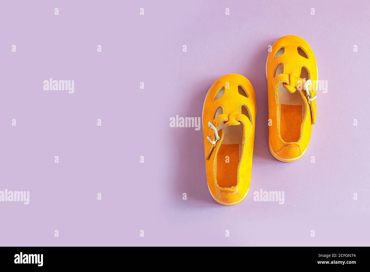 Stylish new yellow shoes on colored pastel background with copyspace ...