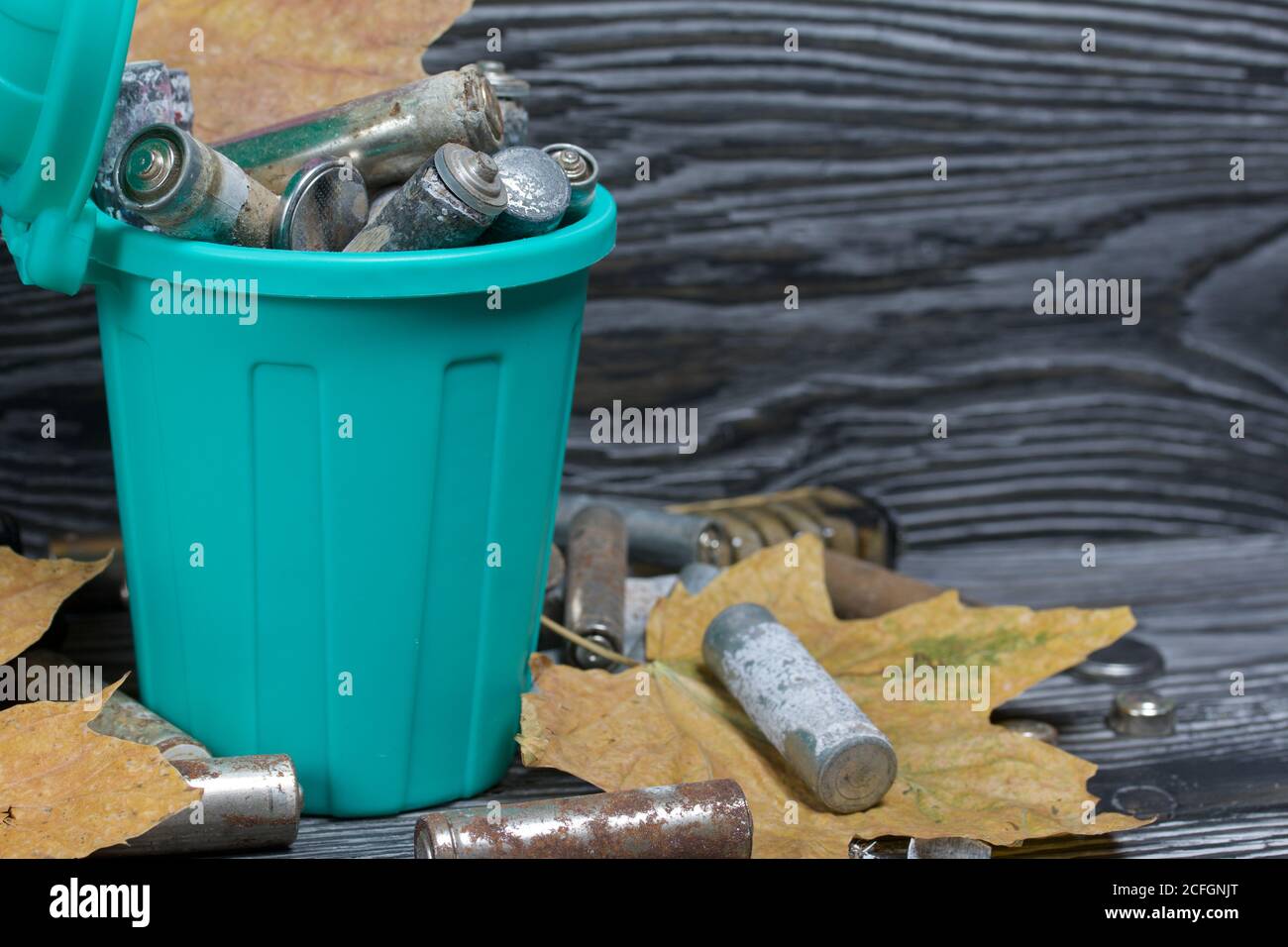 Corroded used batteries. They lie in and around the trash can. Dried ...