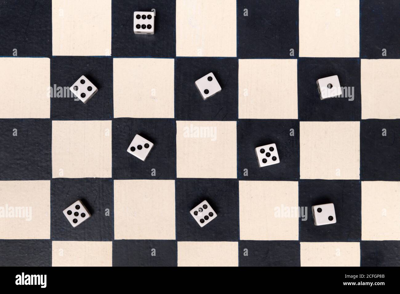 Black and white chessboard with dice showing assorted numbers placed on ...