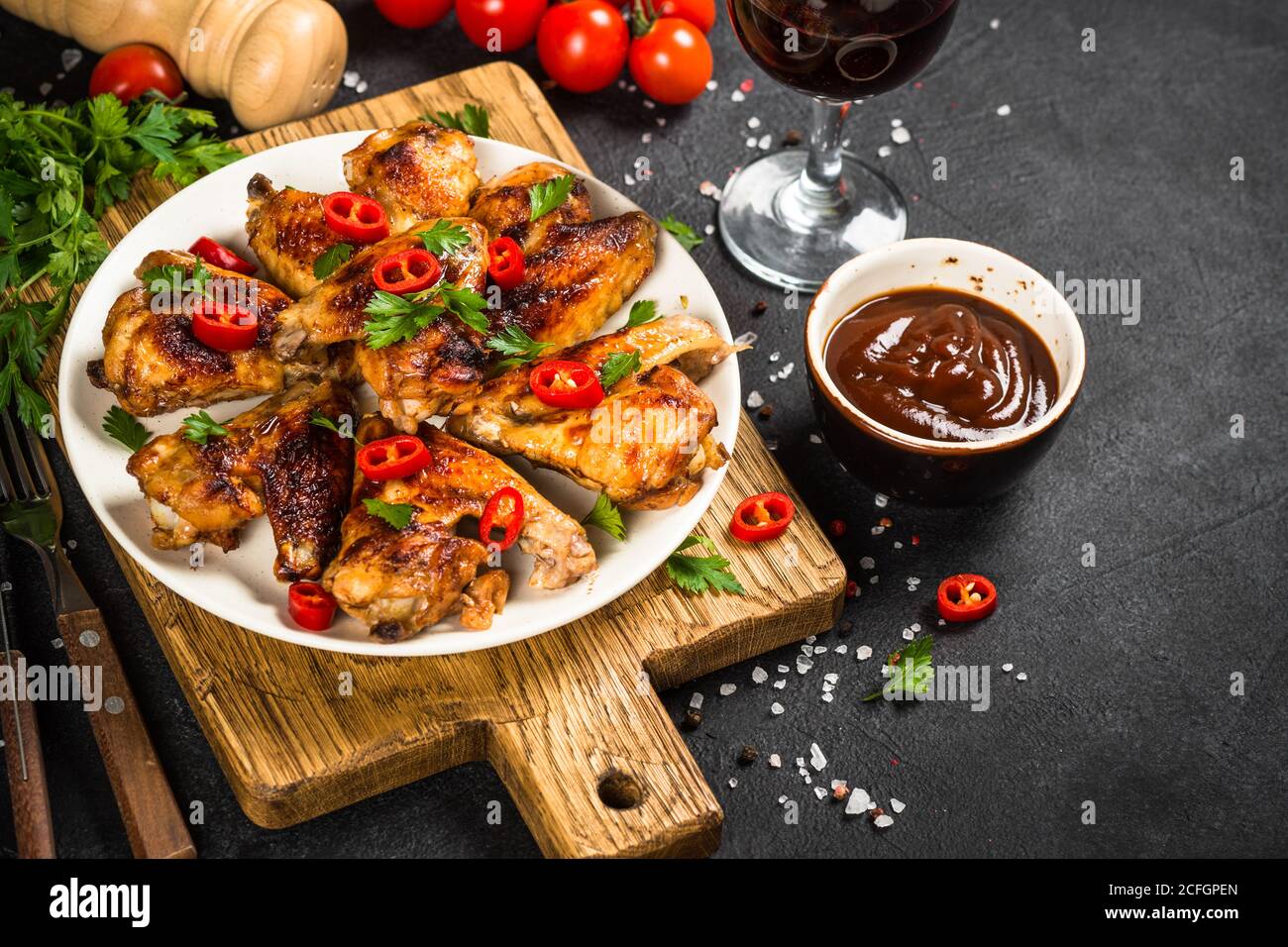 Grilled chicken wings at black Stock Photo - Alamy