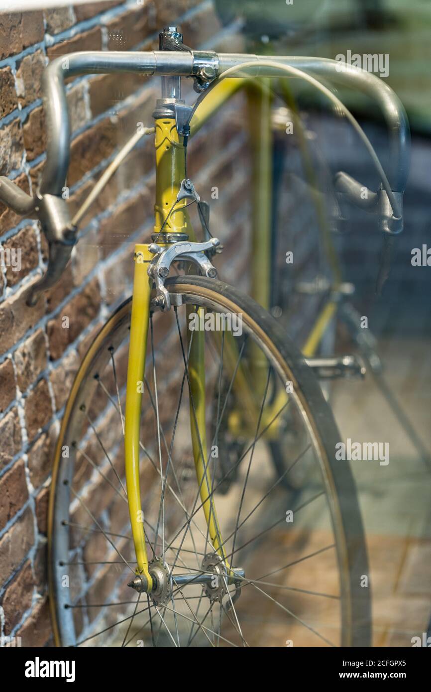 Retro yellow bicycle on roadside with vintage brick wall background ...