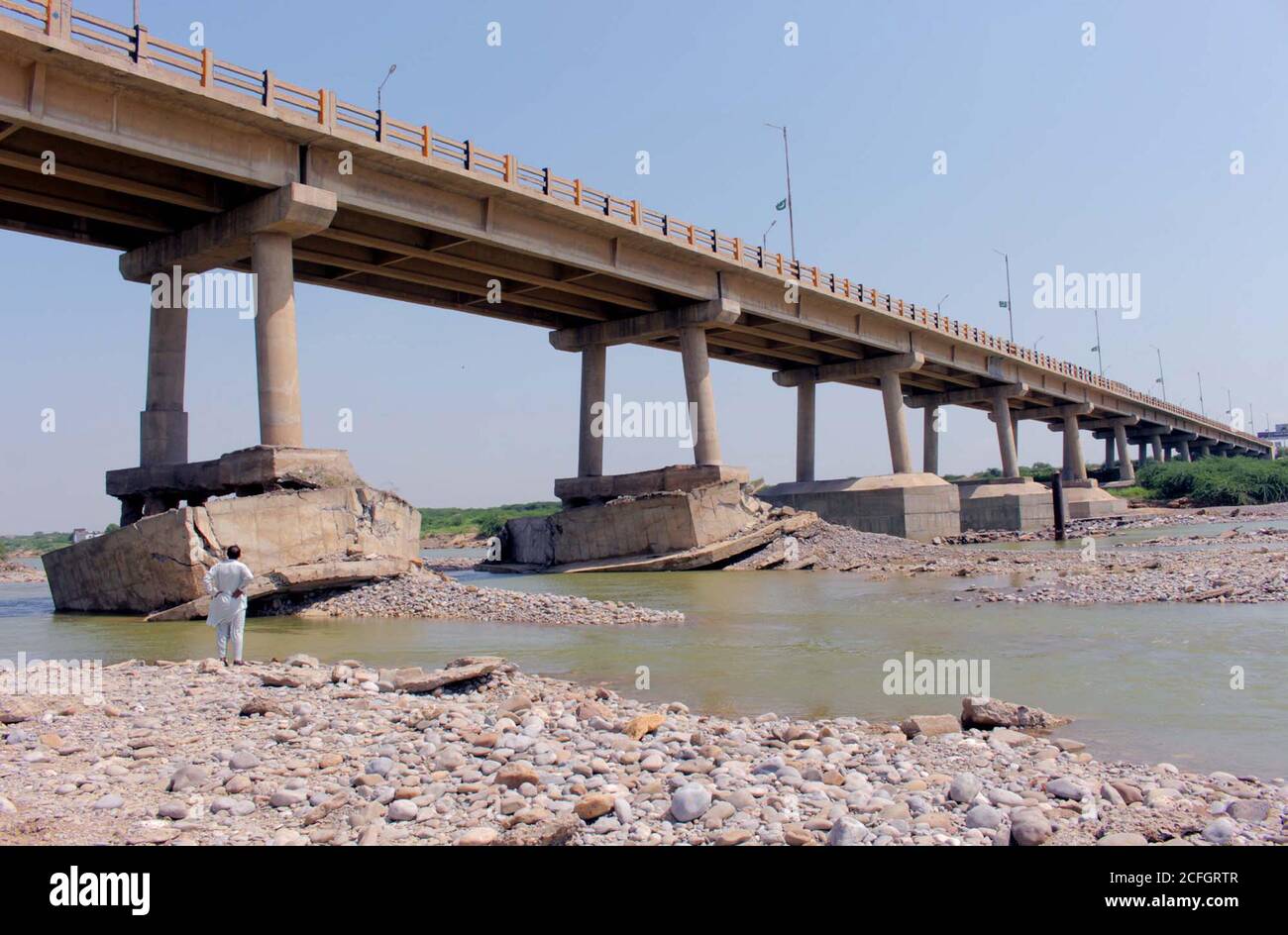 View of damaged bridge over the Hub River is in bad condition and can ...