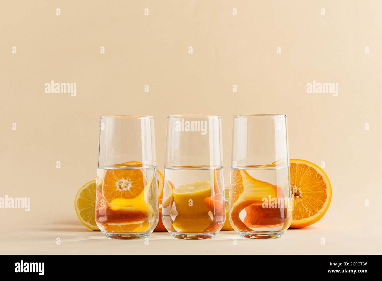 Oranges, tangerine, lemon for glasses of water. Distorted image of ...
