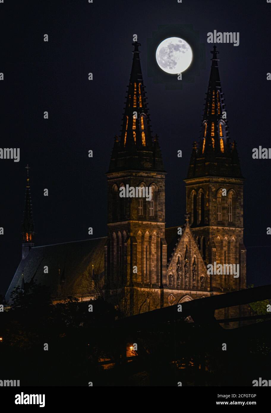 Capture of the full moon centered between the spires of Vyserad Church ...