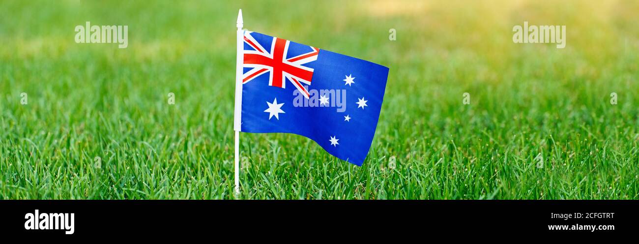 Australian flag standing on green grass. Australia day national holiday ...