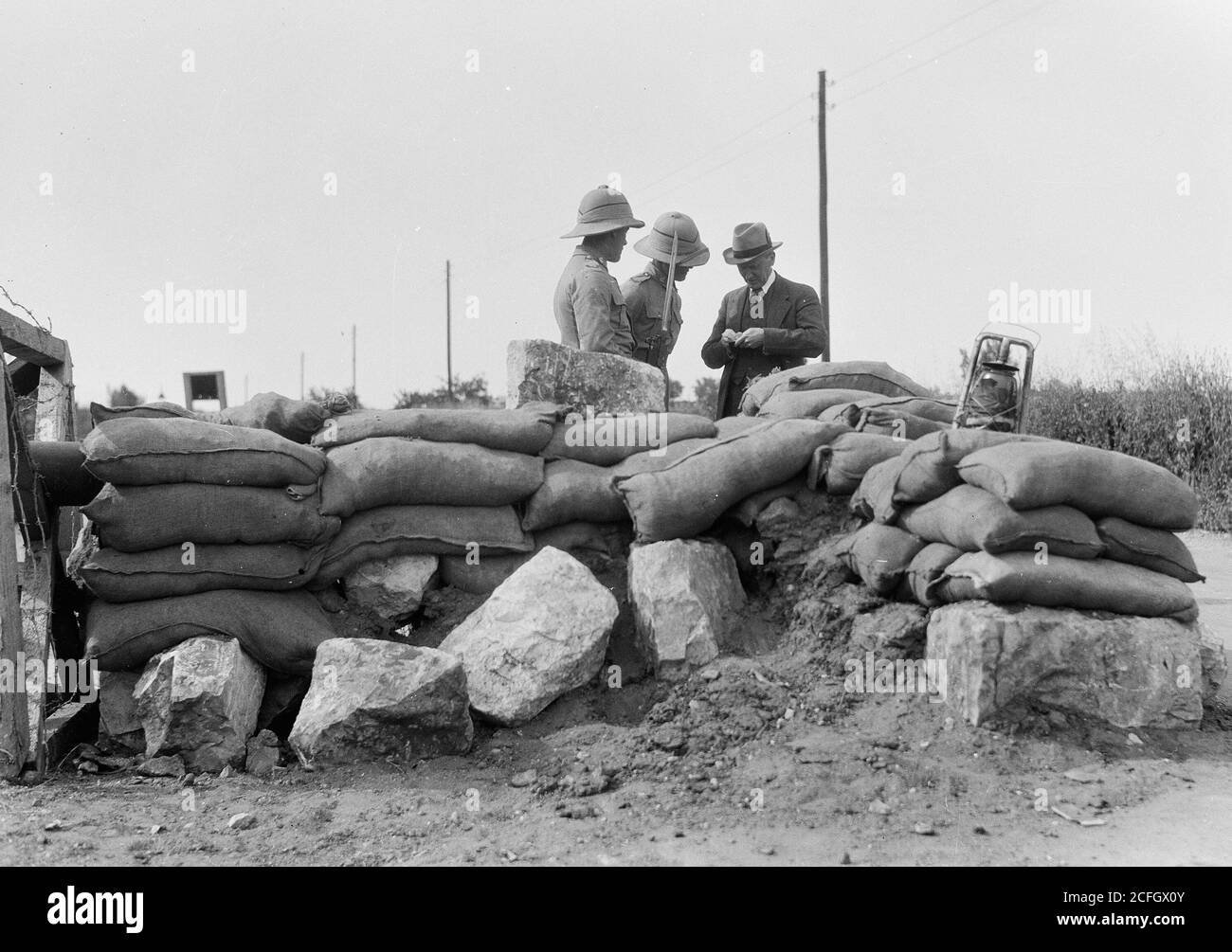 Original Caption: Military road block at junction Ramleh-Lydda Road ...