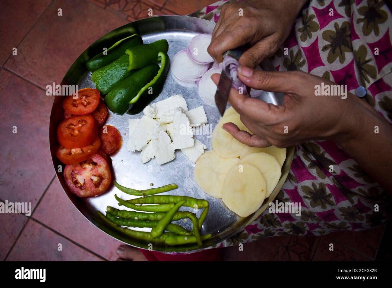 Indian woman chopping vegetables with both hands using knife. Cutting ...