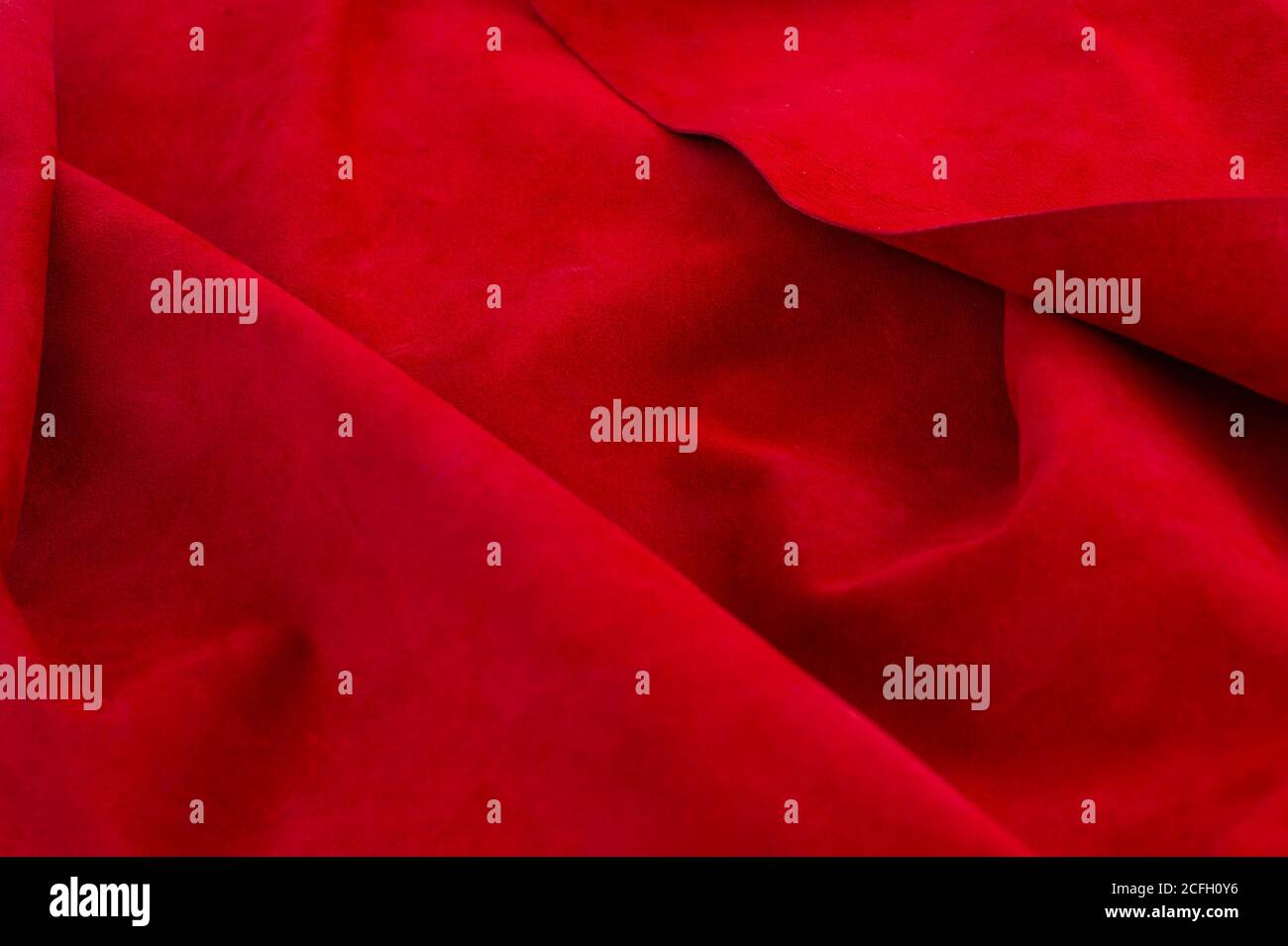 Red matte background of suede fabric, closeup. Velvet texture of ...