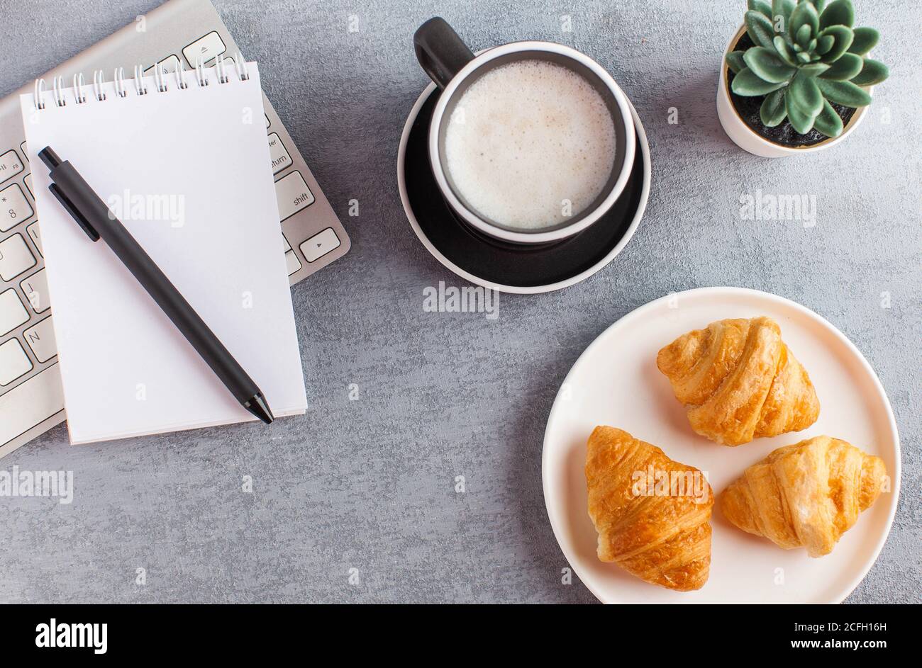 White notebook, coffee and croissant. Blank page of the Notepad to ...