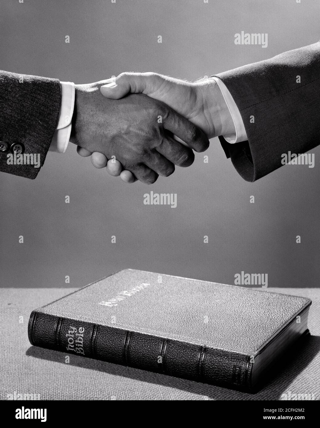 1960s 1970s AN AFRICAN-AMERICAN MAN AND A CAUCASIAN MAN SHAKING HANDS ...