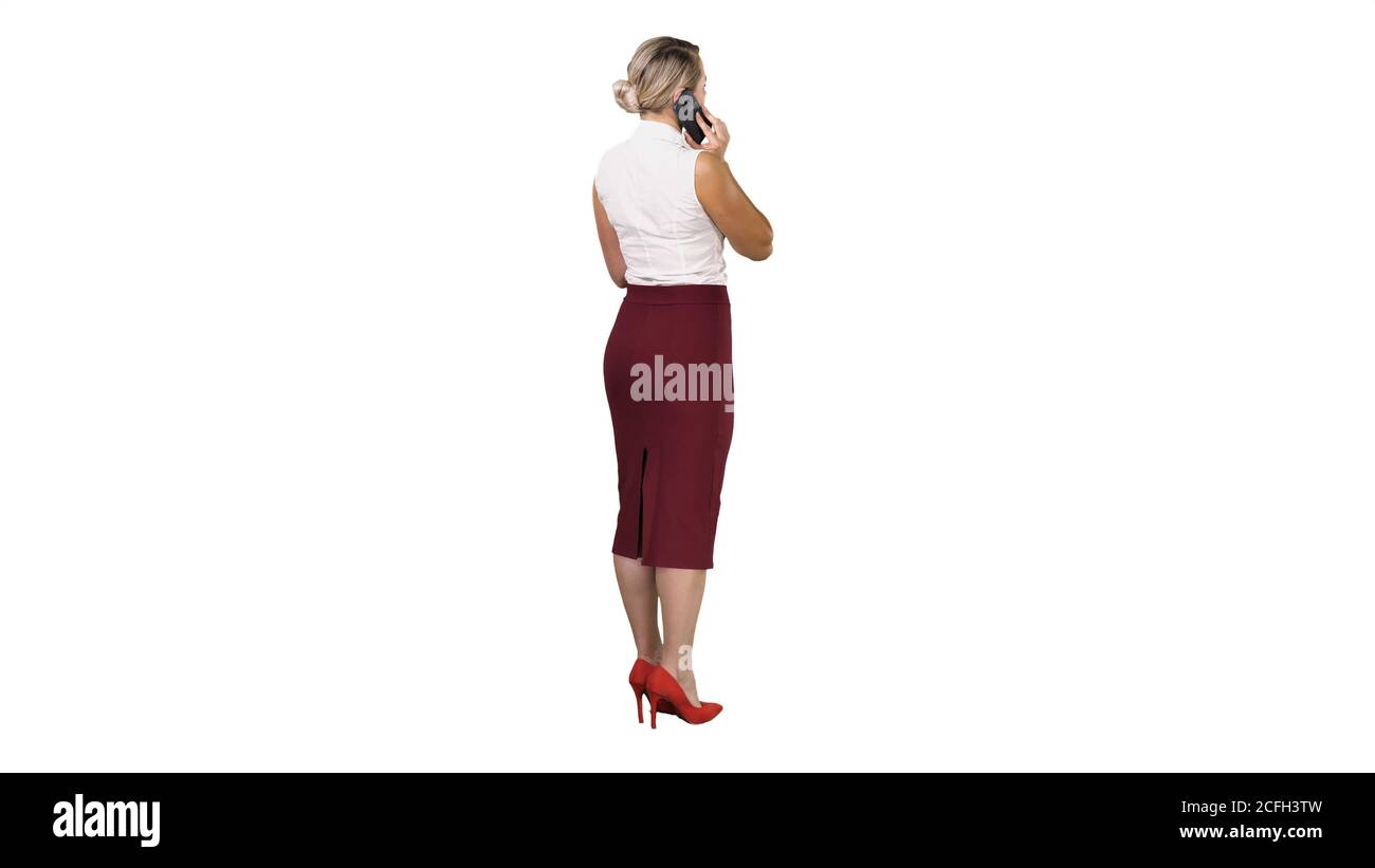 Standing young beautiful woman using a mobile phone making a call on ...