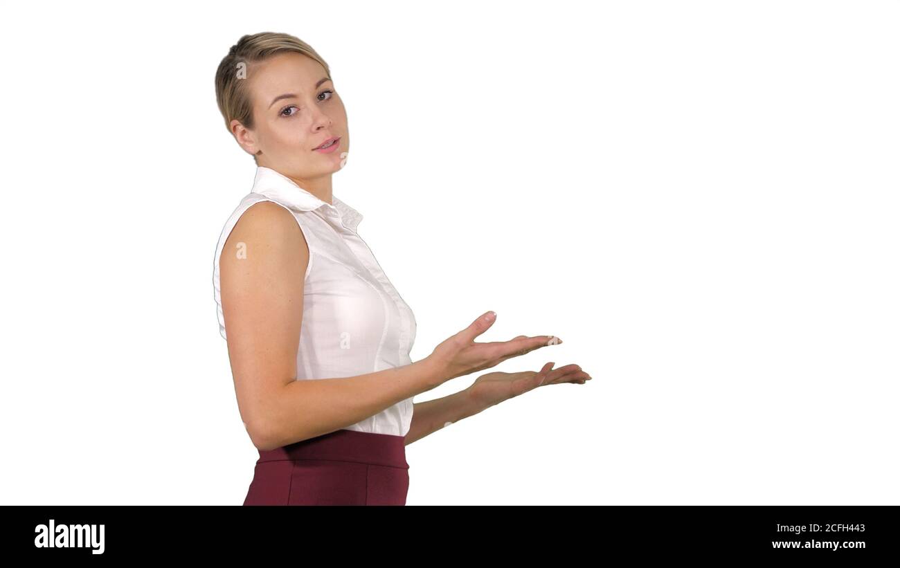 Attractive businesswoman walking and talking to the camera on white ...