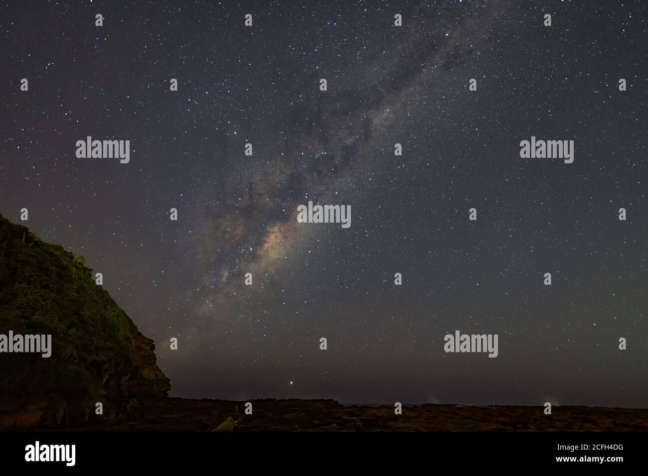 Stars and the Milky Way Night Sky with Rock Platform and Headland taken ...