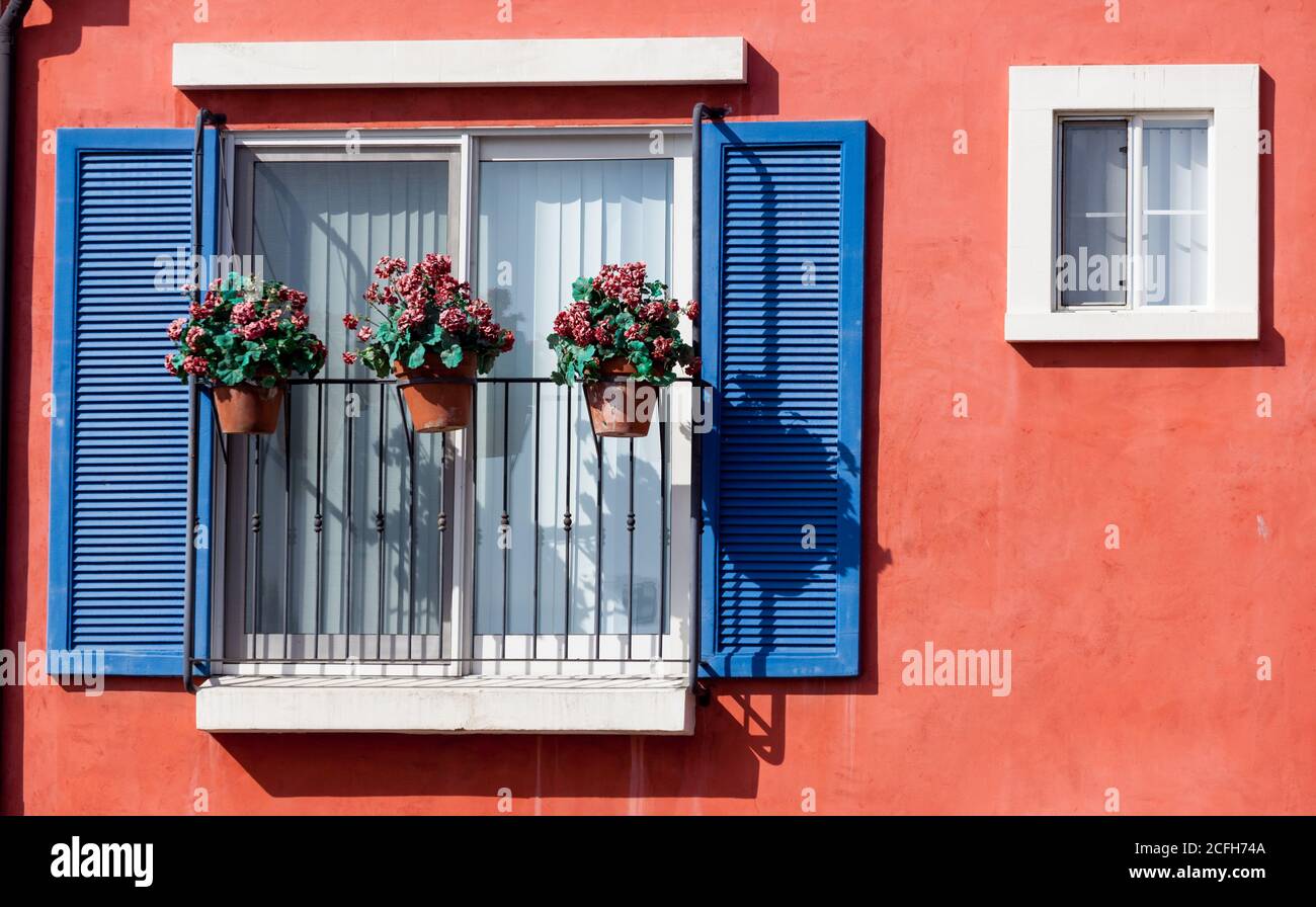 flower pots on outside of a cheerful building Stock Photo - Alamy