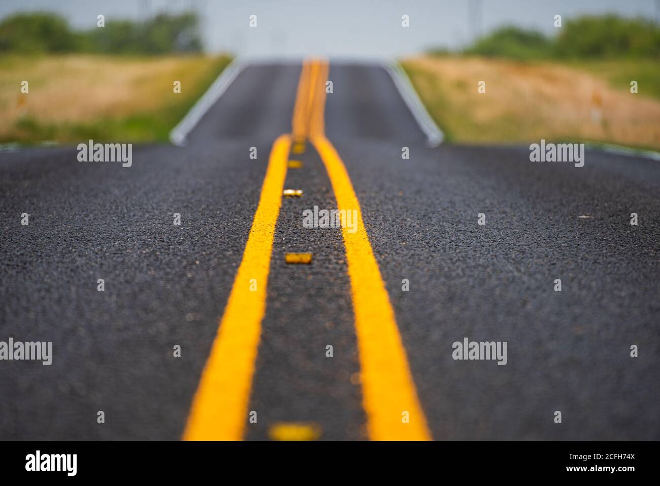 Asphalt road in USA. View of highway road running through the barren ...
