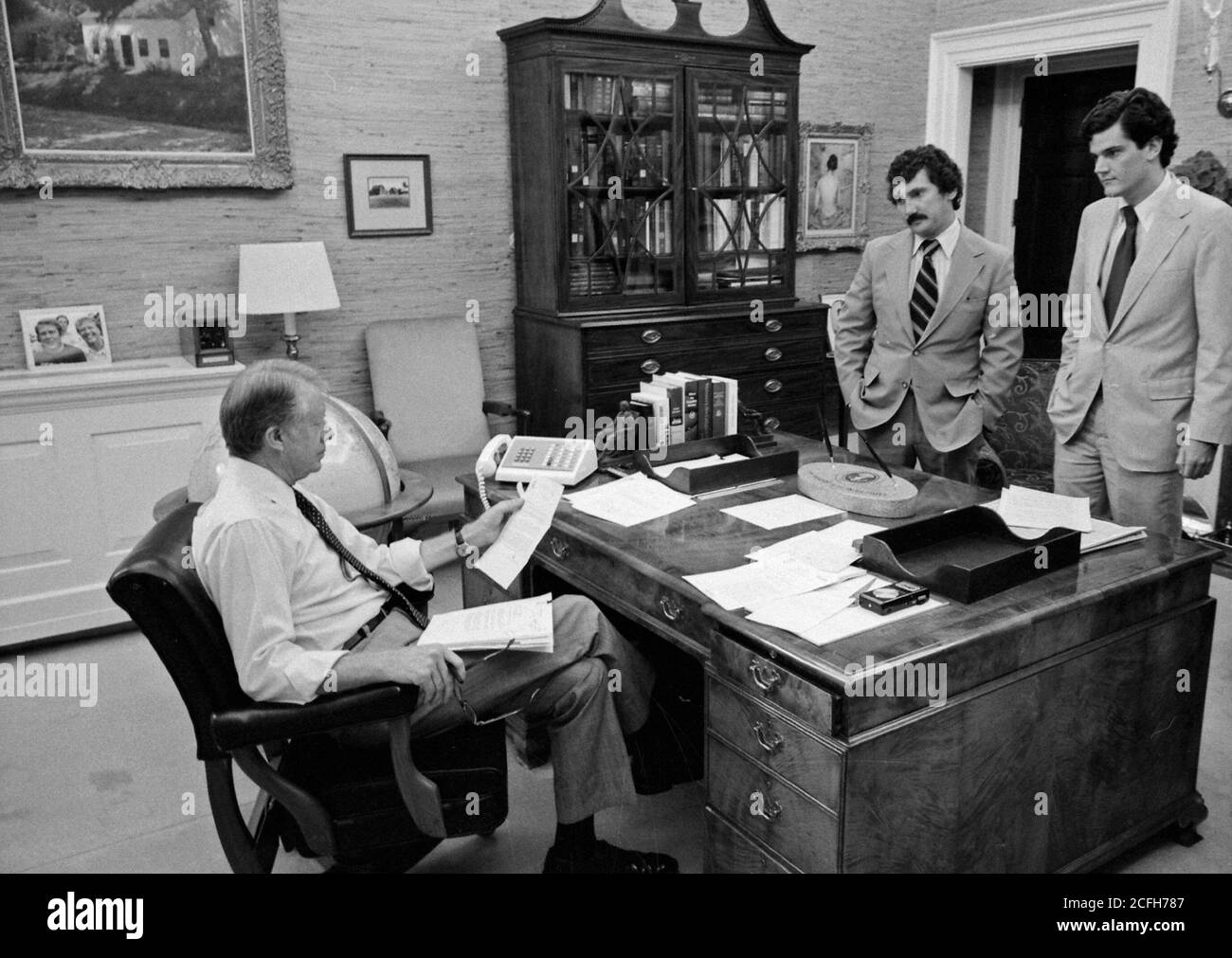 Jimmy Carter in his study with White House staff Tim Kraft and Jim ...