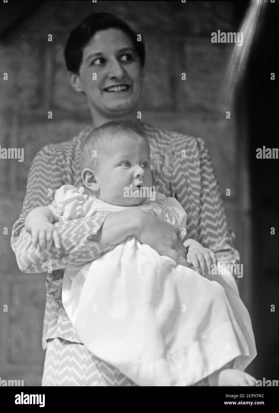 Woman holding a baby in her arms during the 1920s - Location: Africa ca ...