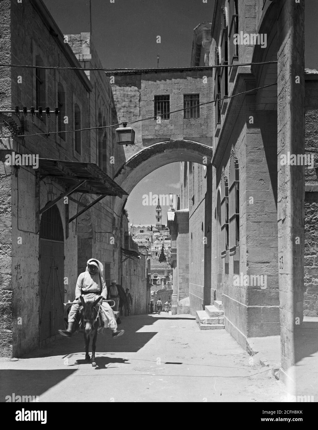 Original Caption: Ecce Homo arch man on donkey - Location: Jerusalem ca ...