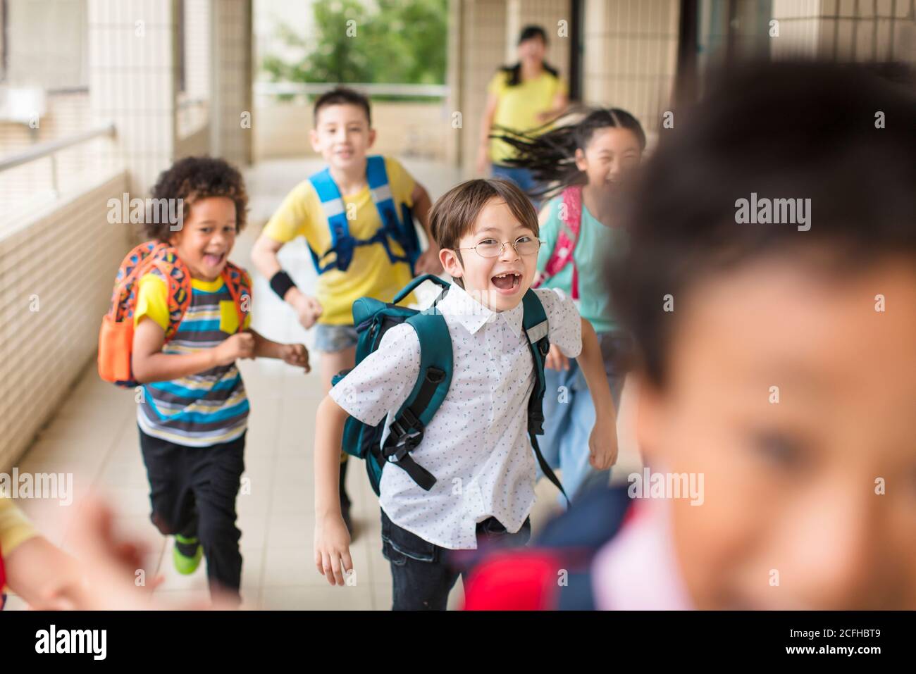 happy Group of elementary school kids running forward Stock Photo - Alamy