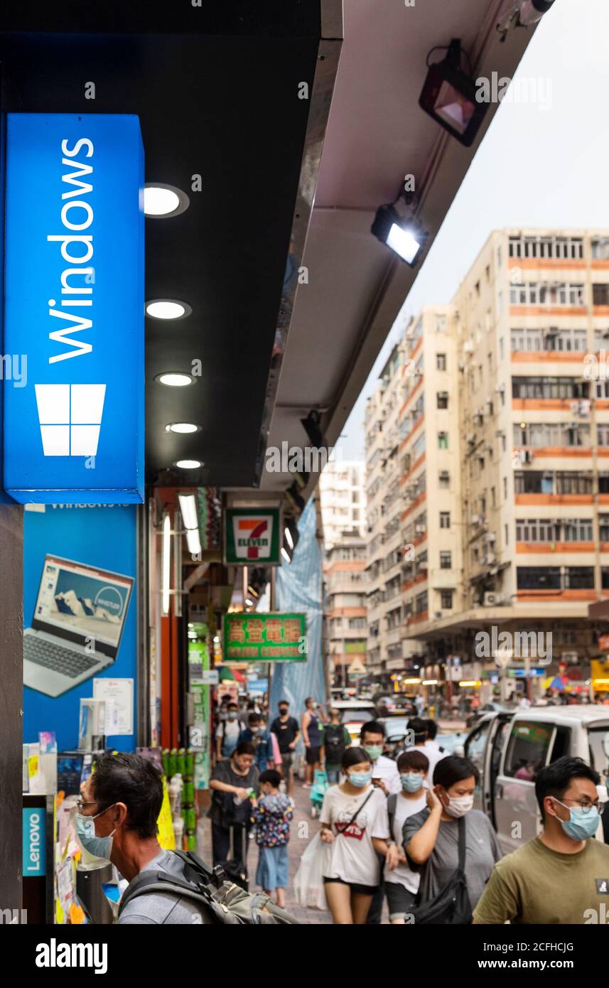 Pedestrians wearing face mask walk past the American multinational ...