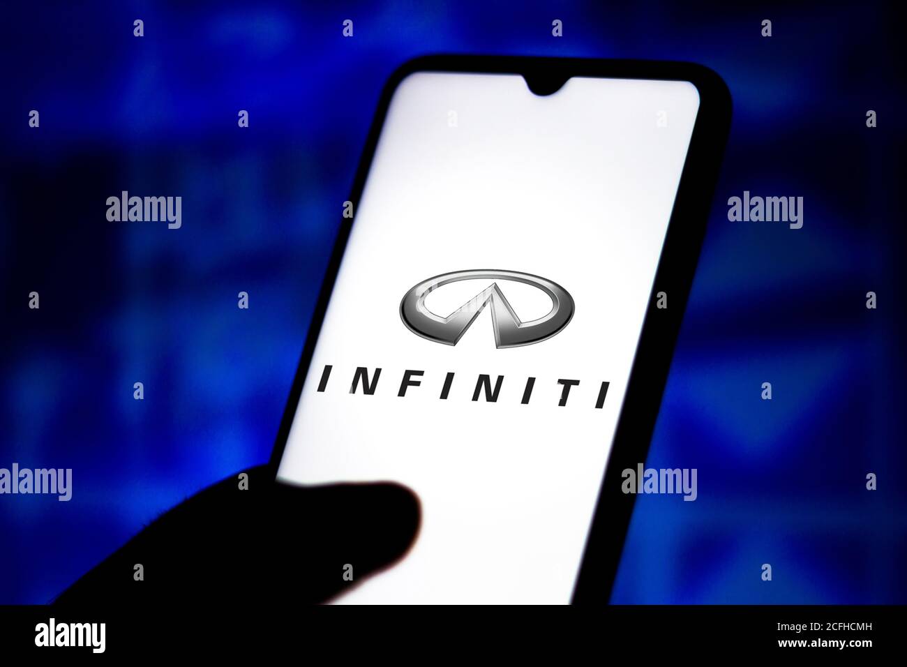 In this photo illustration the Infiniti logo seen displayed on a ...