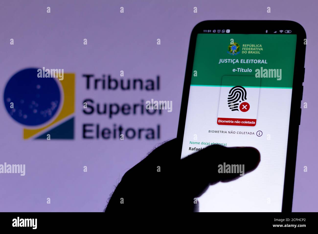 In this photo illustration the e-Título logo seen displayed on a ...