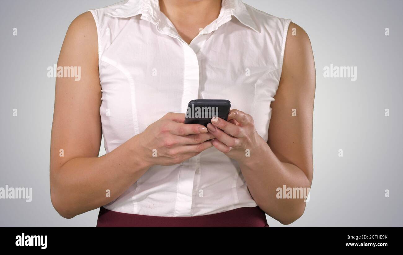 Women's hands holding cell telephone on gradient background Stock Photo ...