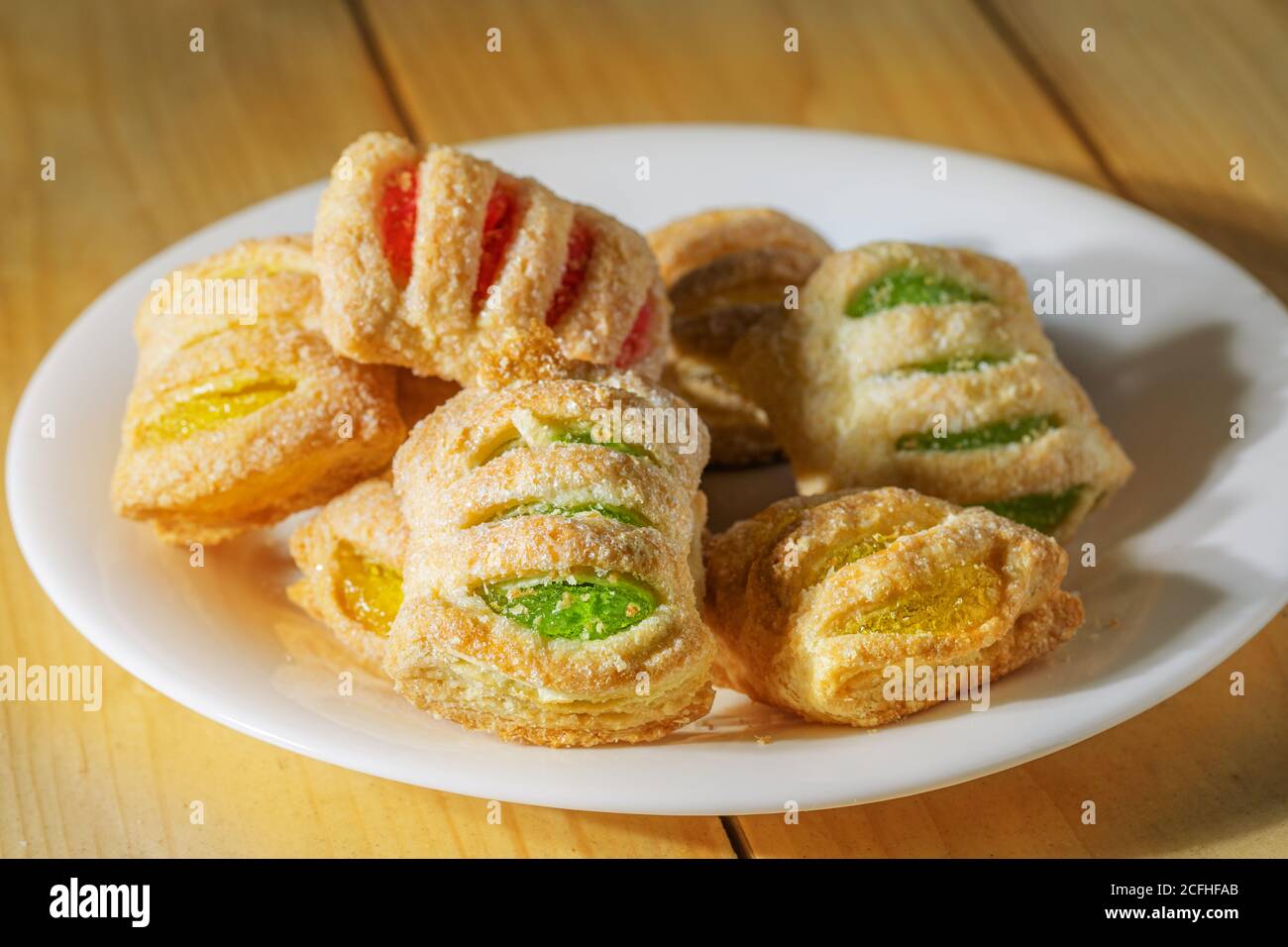 cookies from puff pastry with colored jam Stock Photo - Alamy