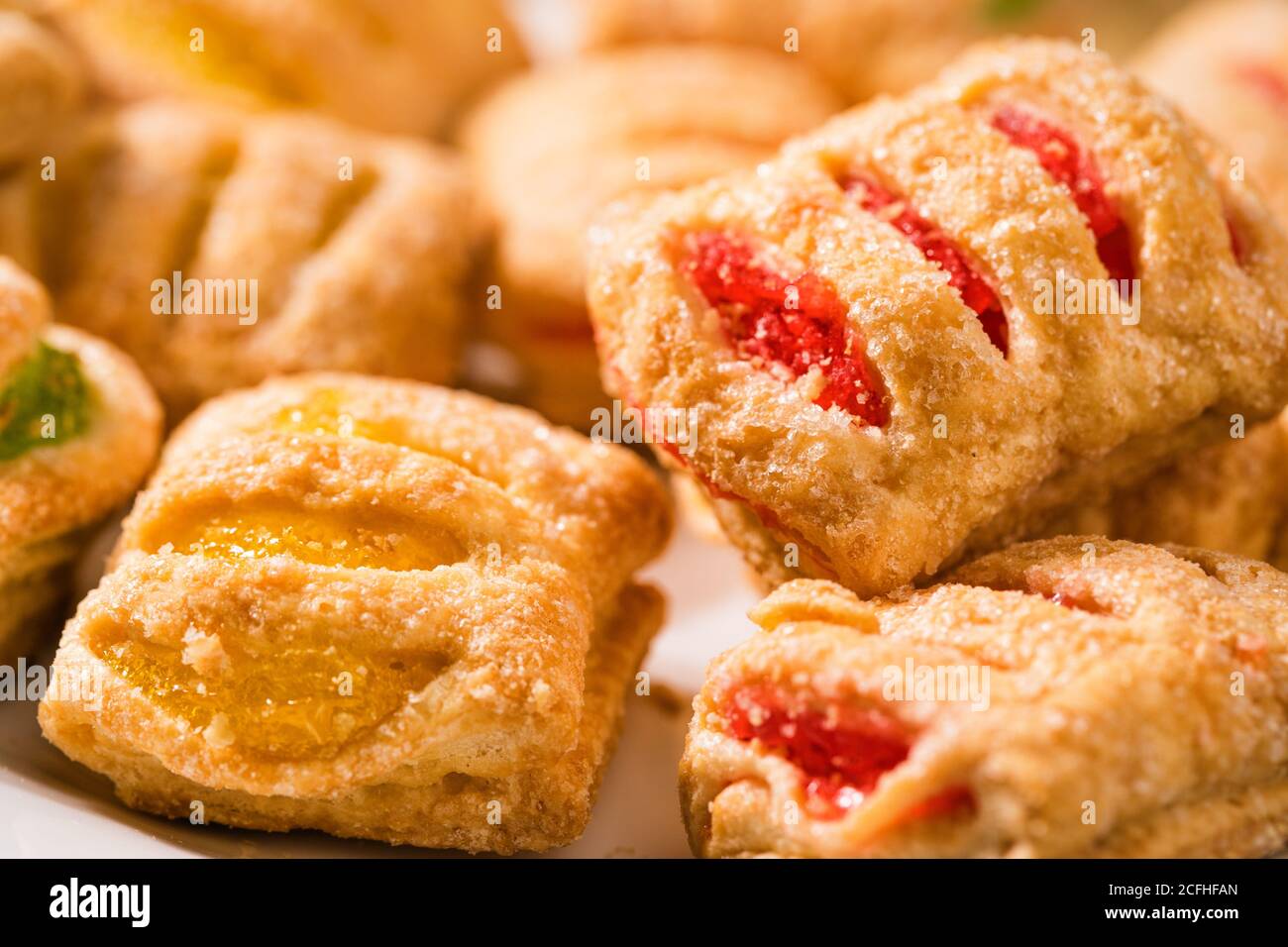 cookies from puff pastry with colored jam Stock Photo - Alamy